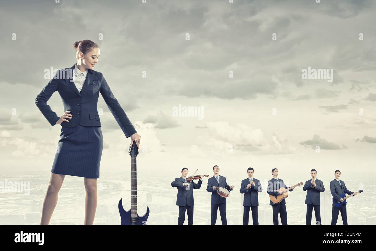 Man orchestra playing different music instruments and woman leader ...