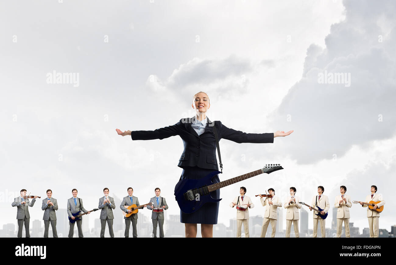 Man orchestra playing different music instruments and woman leader ...