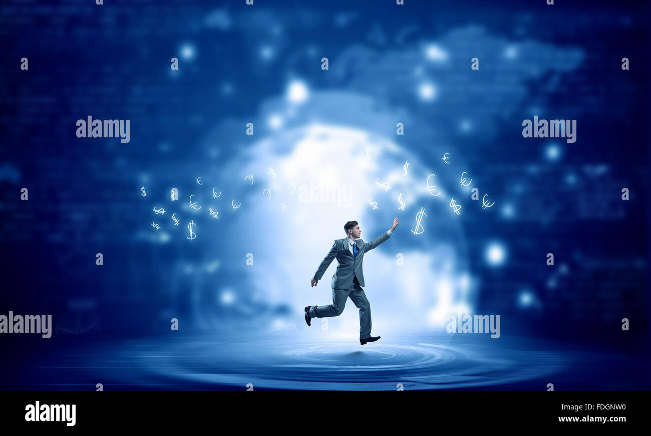 Running young businessman trying to catch dollar signs falling from ...