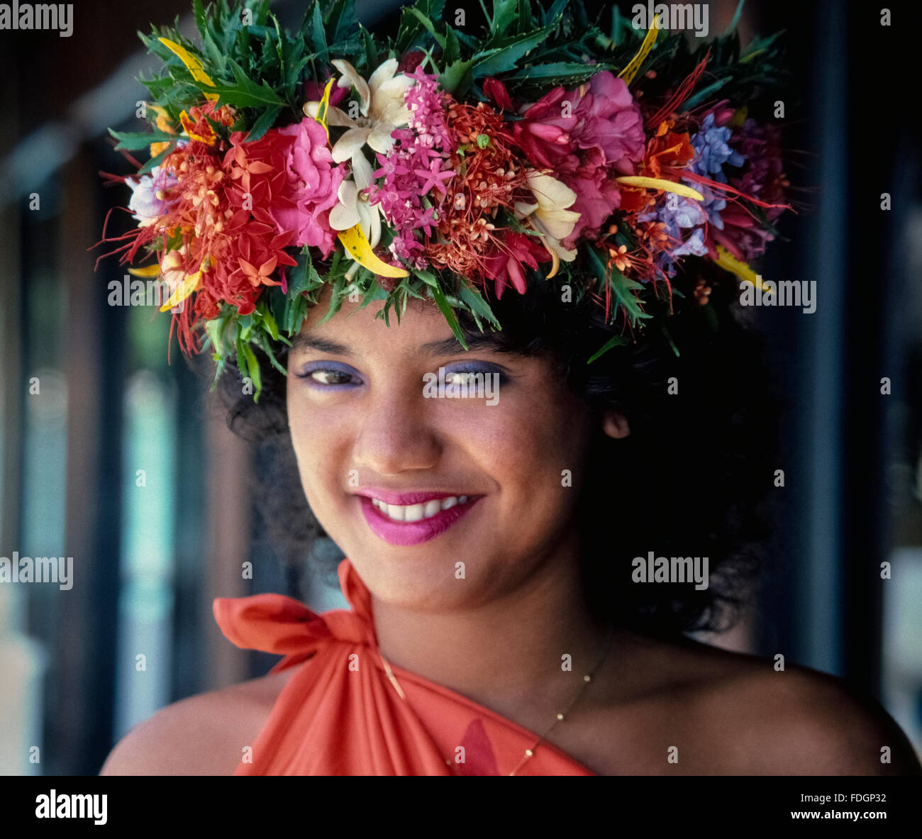 A traditional Tahitian floral crown adds to the beauty of this smiling ...