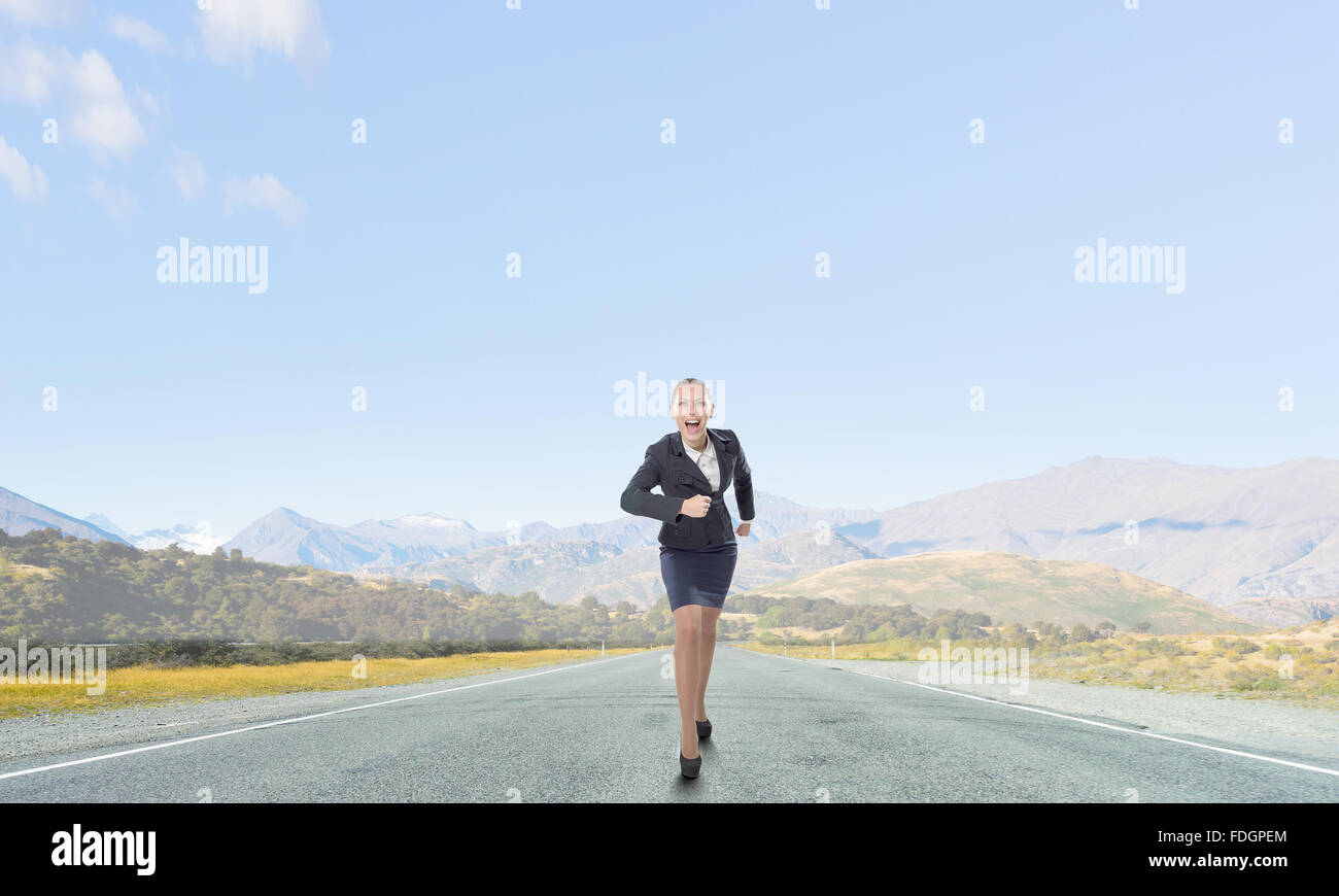Young determined businesswoman competitor running on road Stock Photo ...