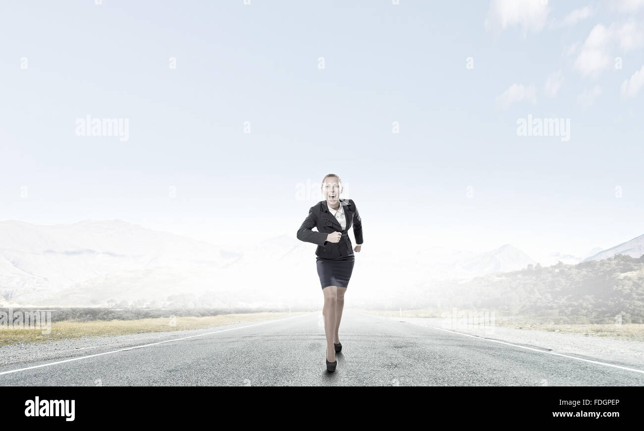 Young determined businesswoman competitor running on road Stock Photo ...