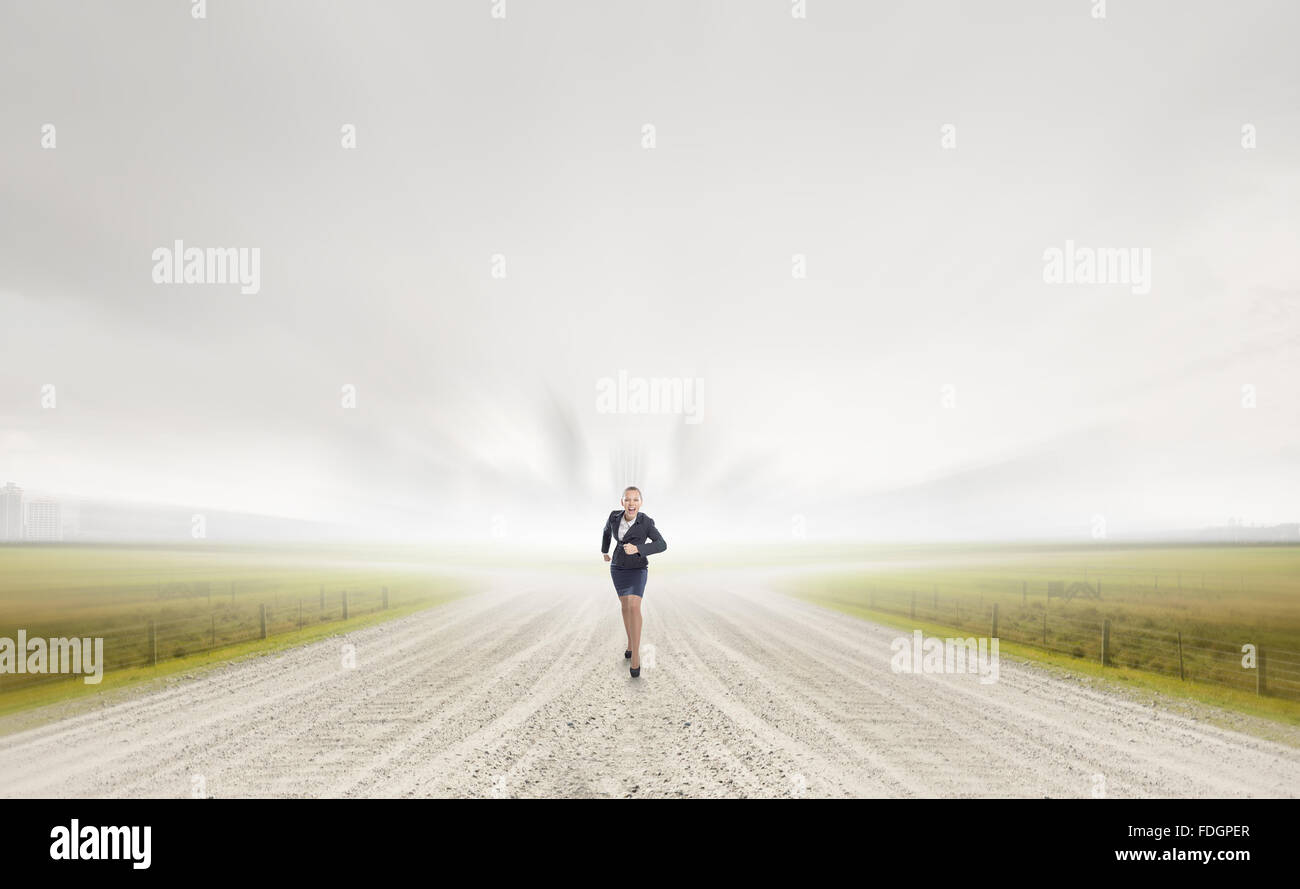 Young determined businesswoman competitor running on road Stock Photo ...