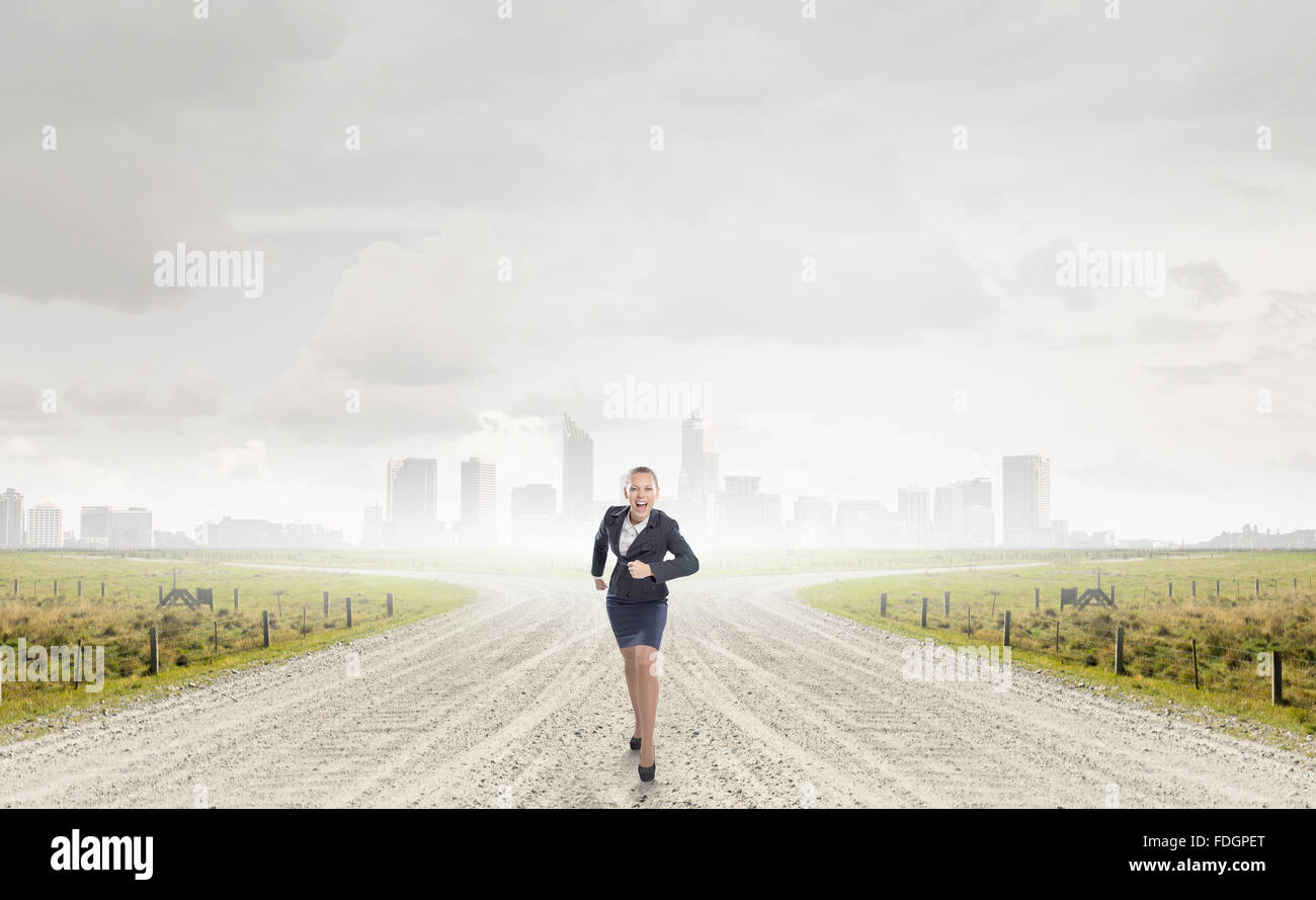 Young determined businesswoman competitor running on road Stock Photo ...
