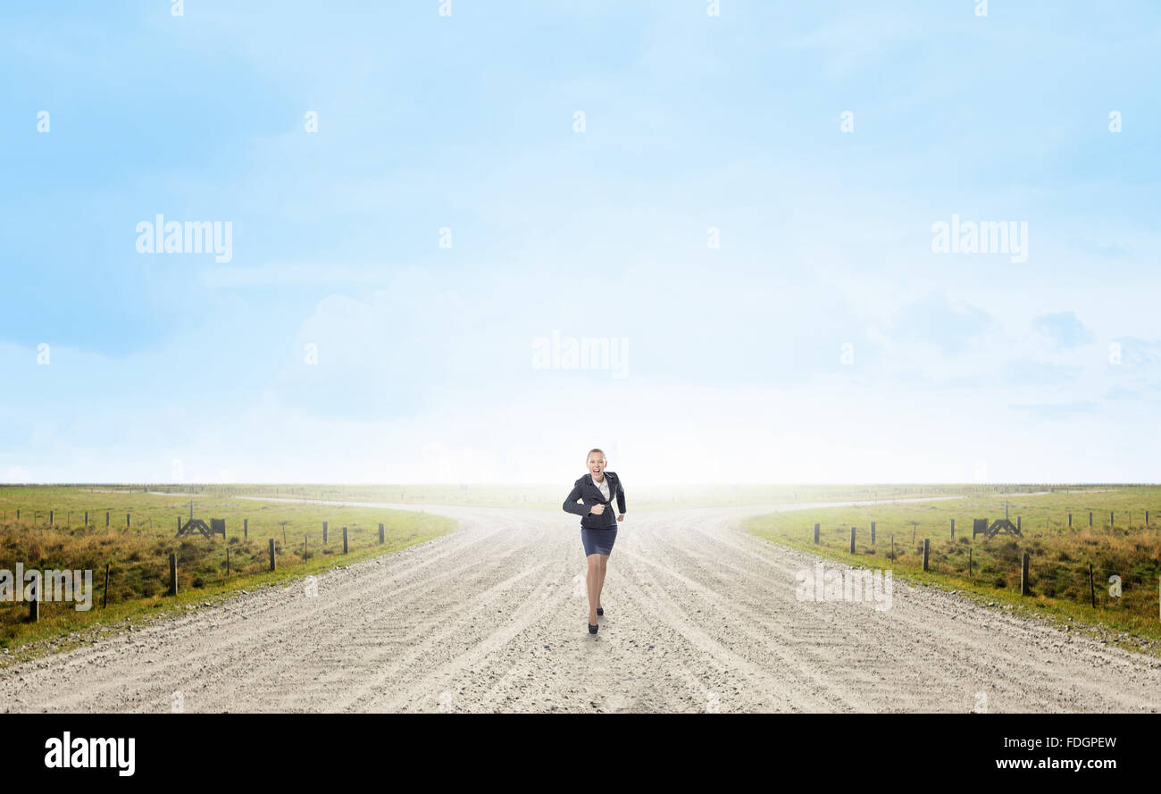 Young determined businesswoman competitor running on road Stock Photo ...
