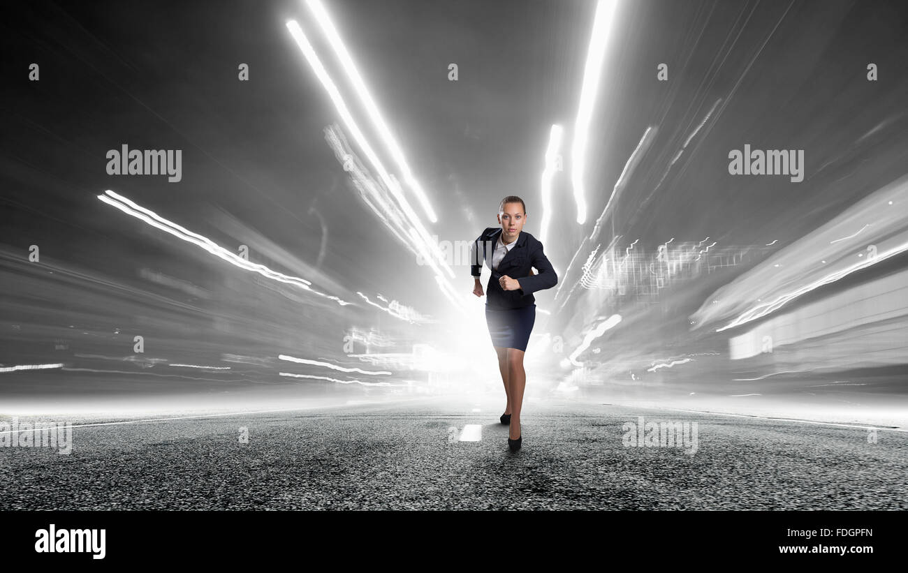 Young determined businesswoman competitor running on road Stock Photo ...