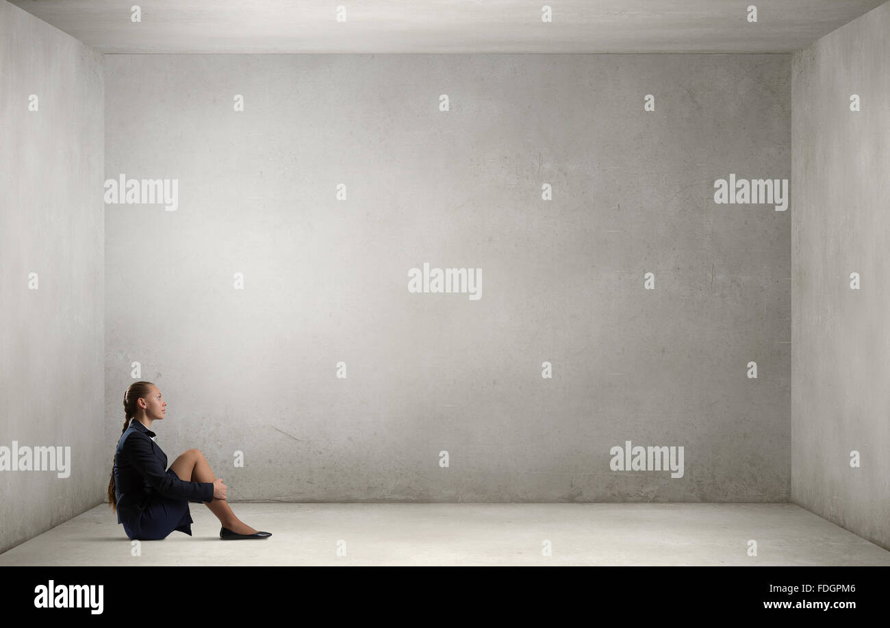 Bored young businesswoman sitting alone on floor Stock Photo - Alamy