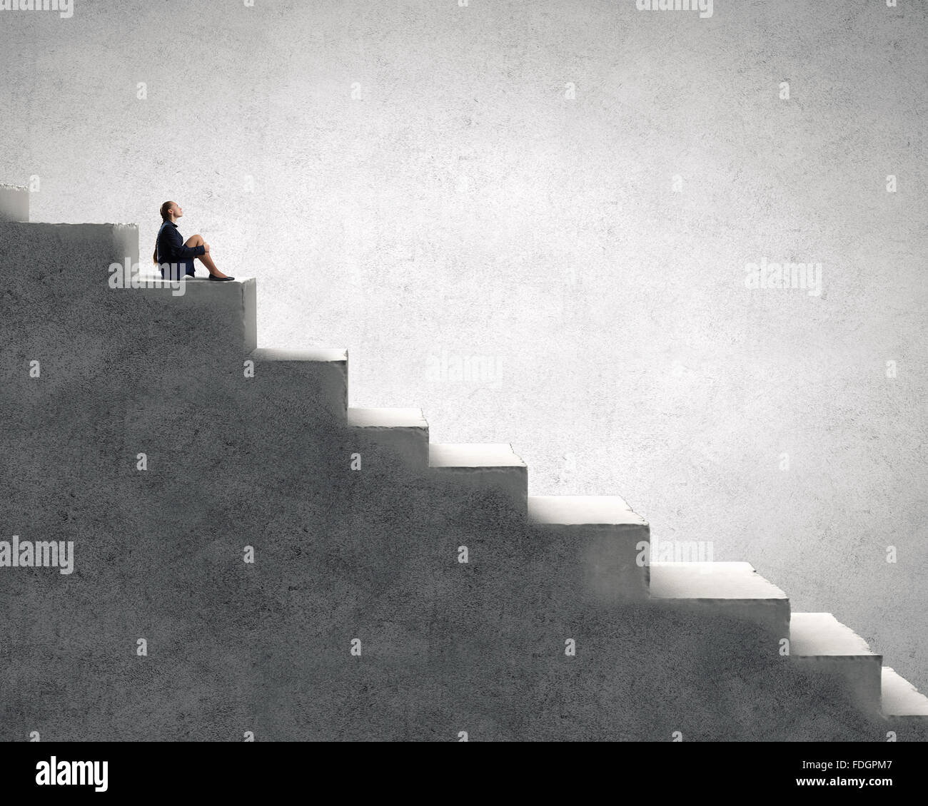 Bored young businesswoman sitting alone on ladder steps Stock Photo - Alamy