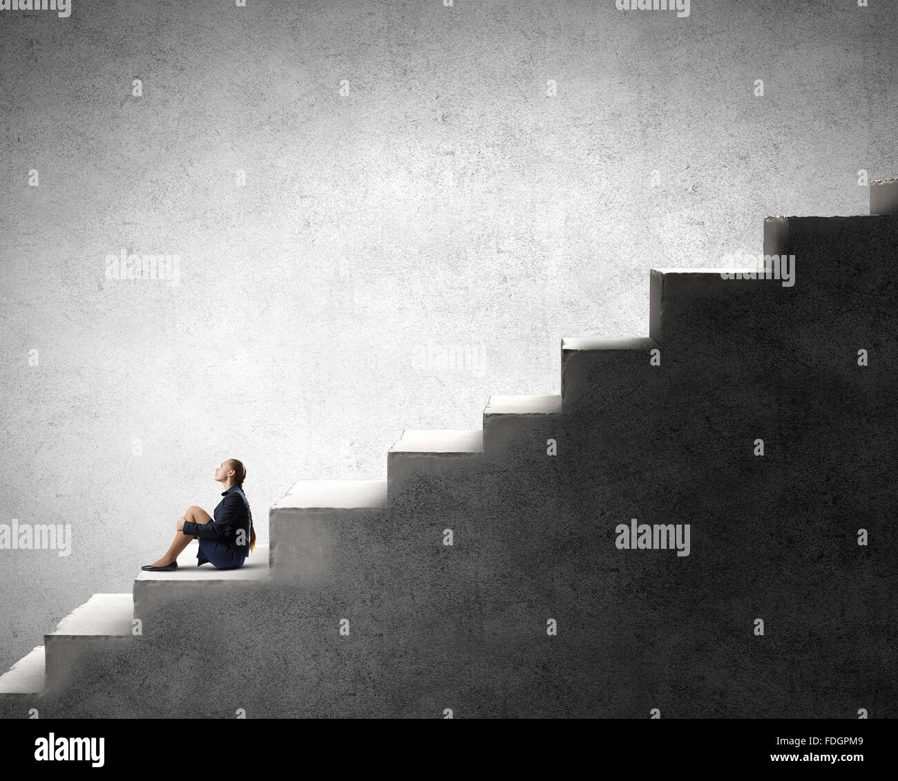 Bored young businesswoman sitting alone on ladder steps Stock Photo - Alamy