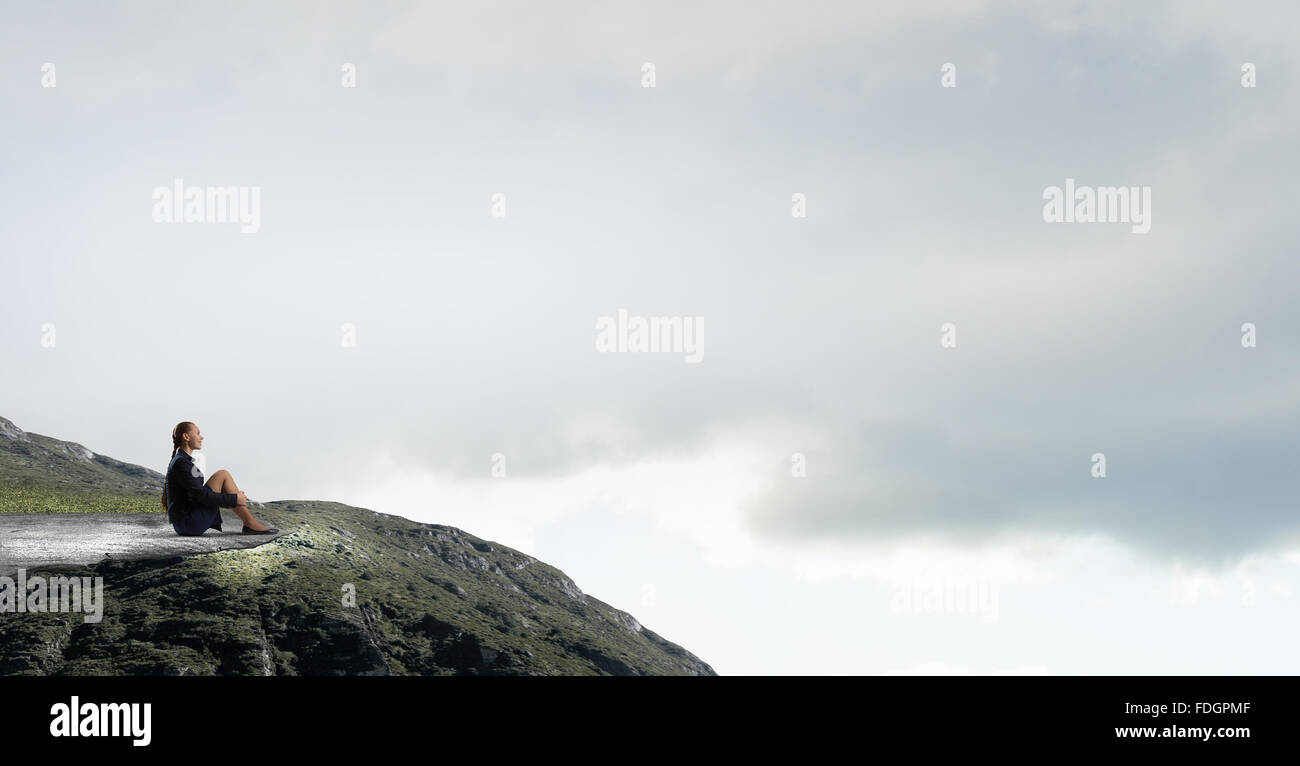 Bored young businesswoman sitting alone on top hi-res stock photography ...
