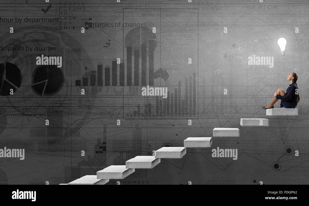 Bored young businesswoman sitting alone on ladder steps Stock Photo - Alamy