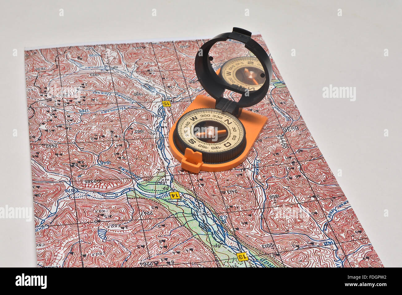 Compass and map. The magnetic compass is lying on a topographical map ...