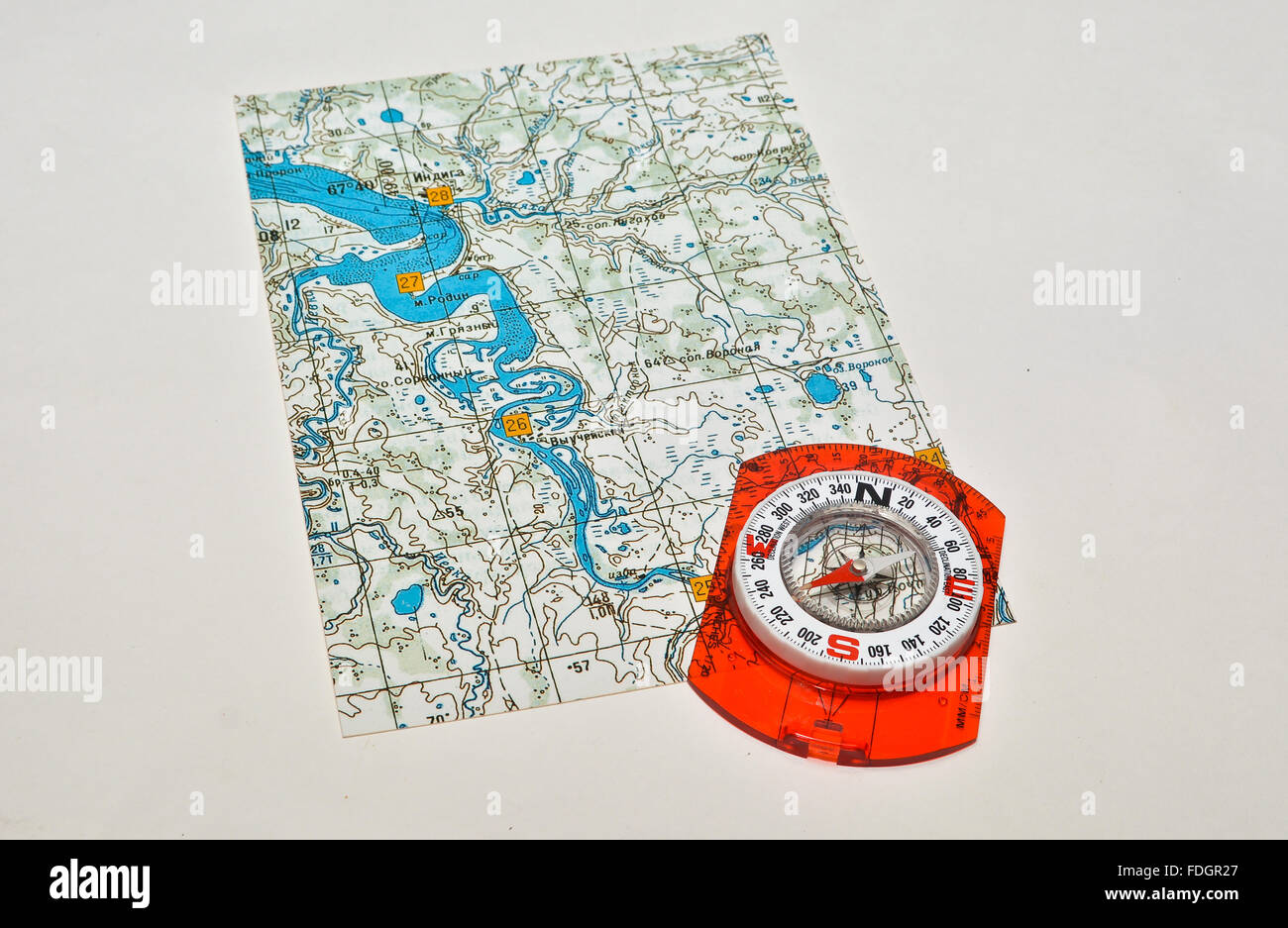 Compass and map. The magnetic compass is lying on a topographical map ...