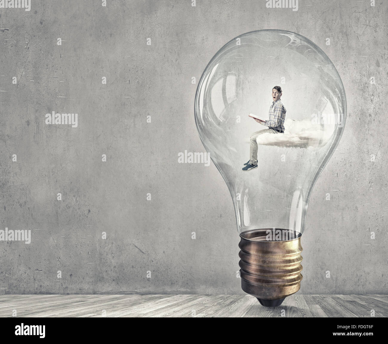 Young businessman inside of light bulb reading book Stock Photo - Alamy