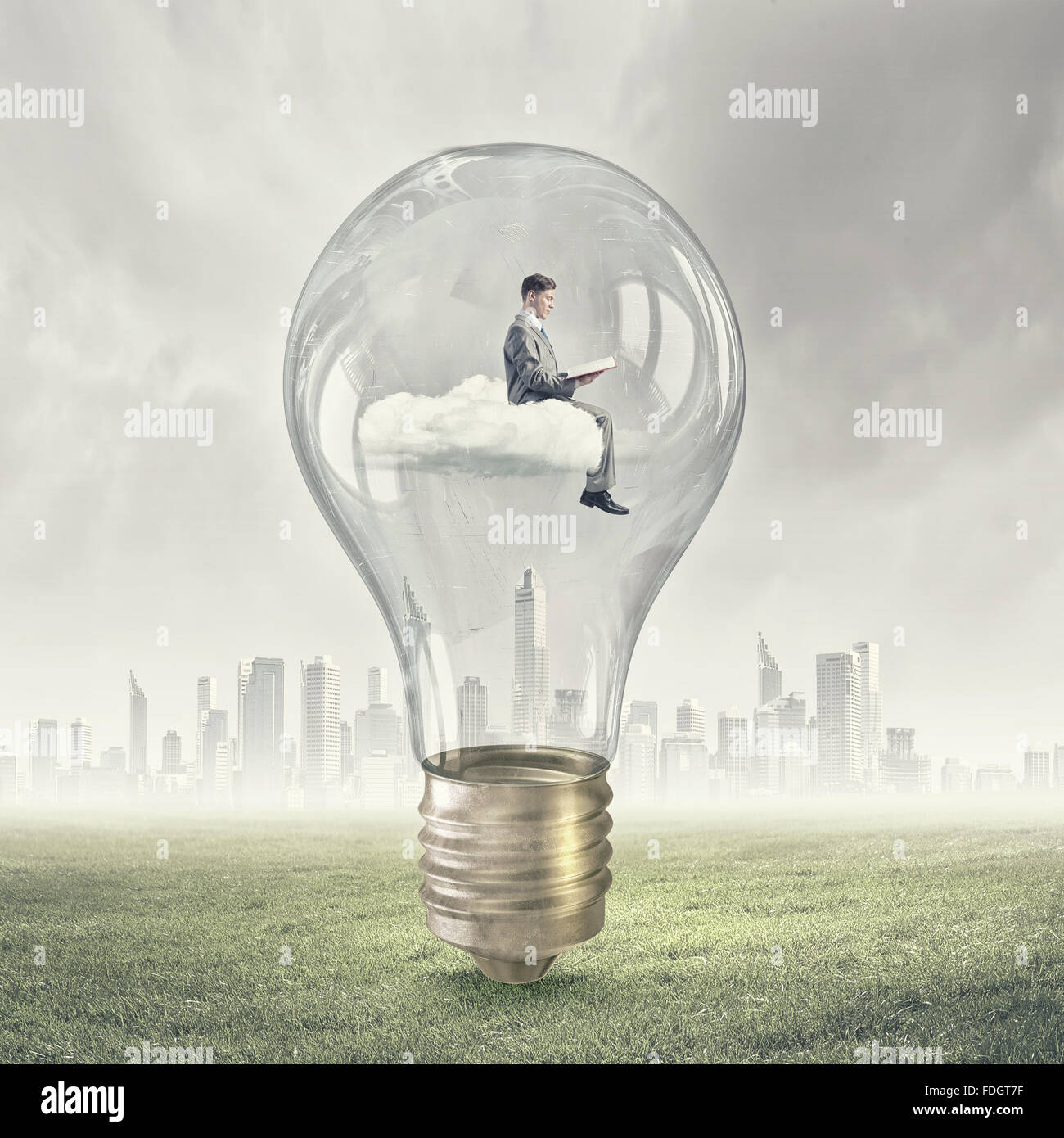 Young businessman inside of light bulb reading book Stock Photo - Alamy