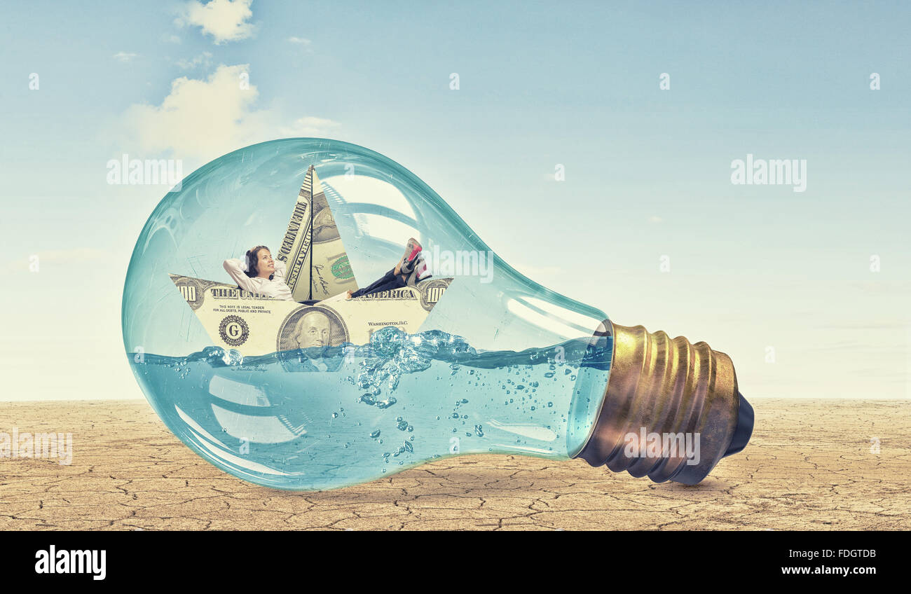 Businesswoman floating on paper boat made of dollar banknote inside ...