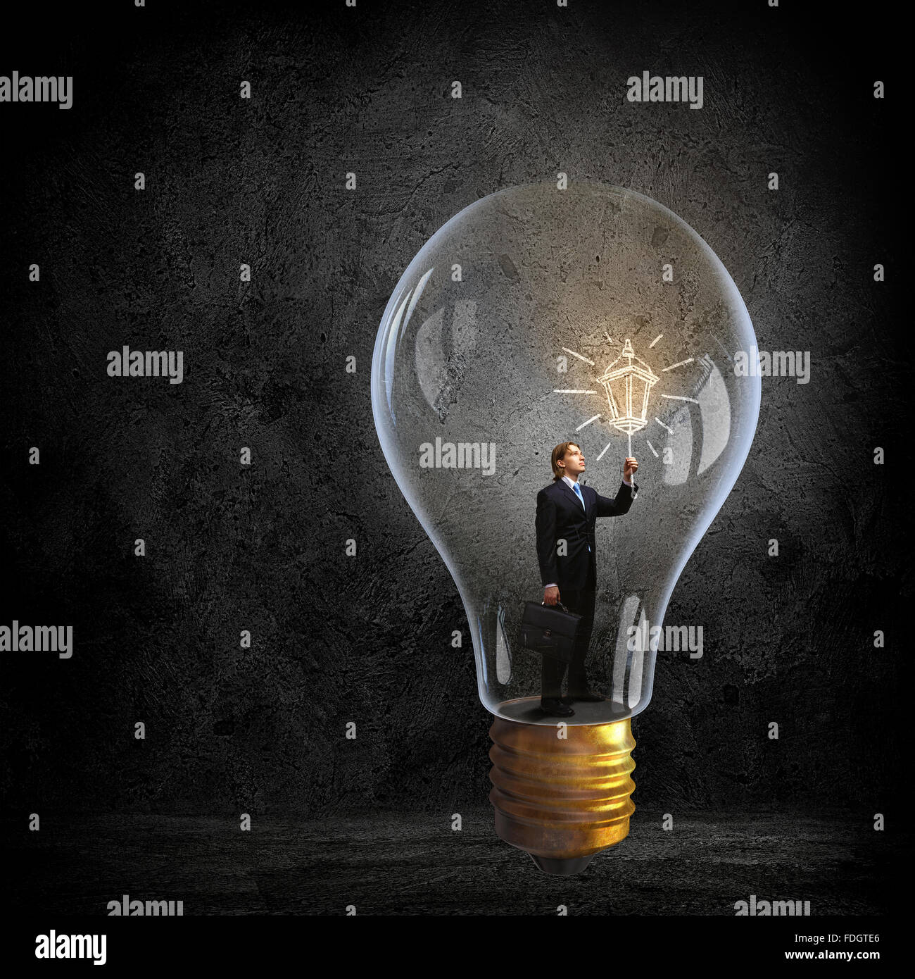 Businessman inside of glass light bulb on dark background Stock Photo ...