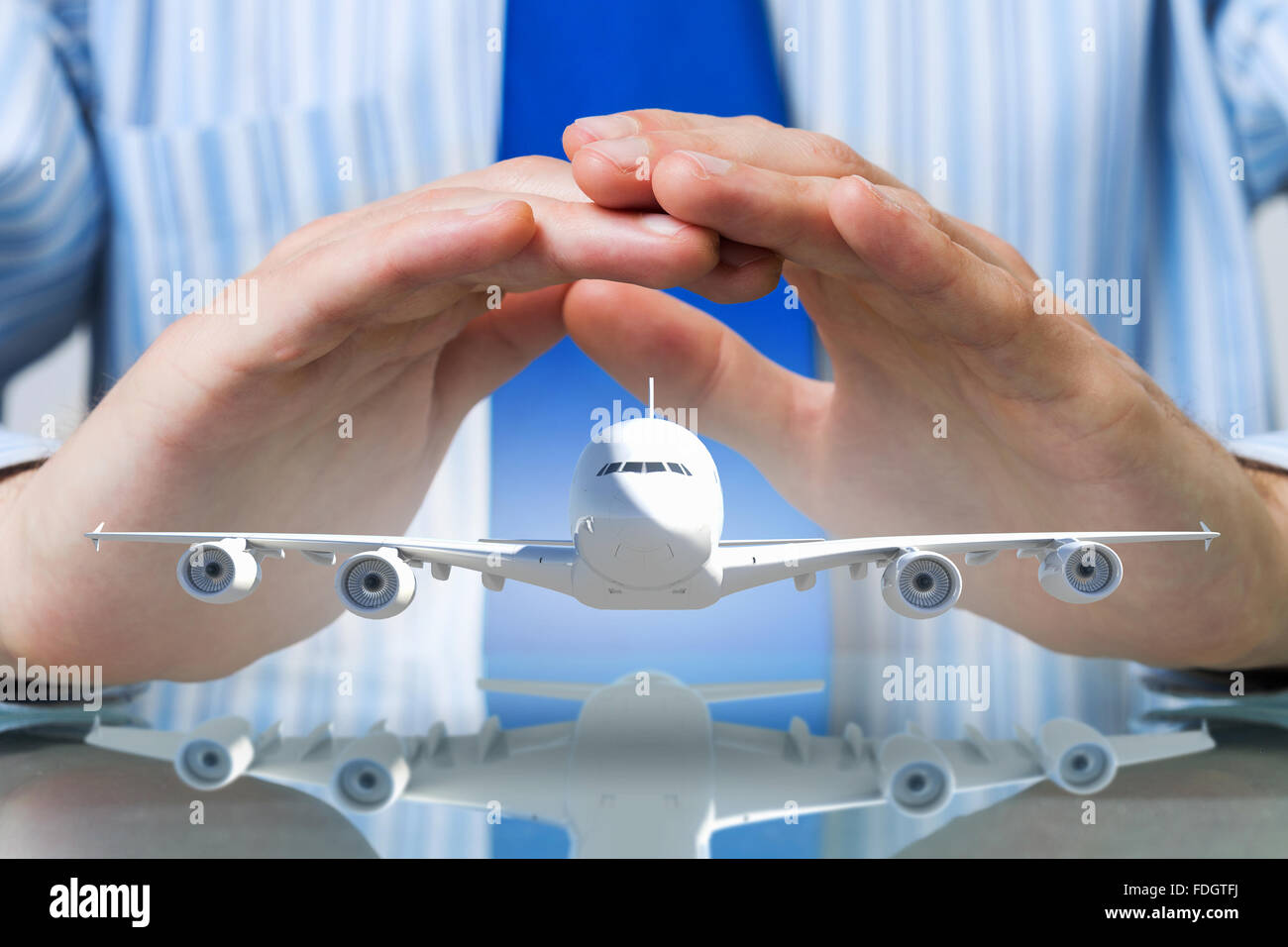 Hands of businessman and model of flying airplane Stock Photo - Alamy