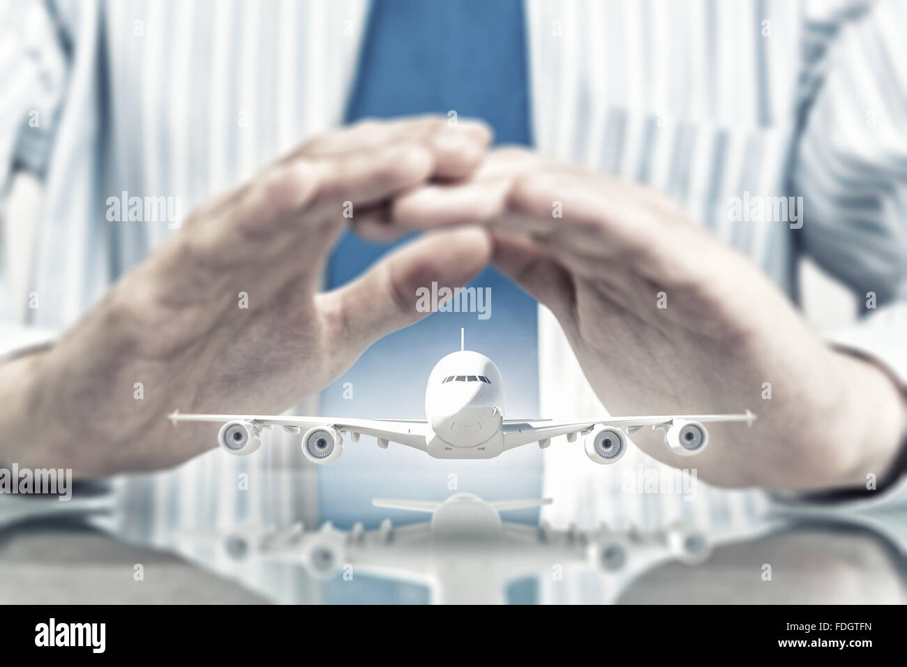 Hands of businessman and model of flying airplane Stock Photo - Alamy