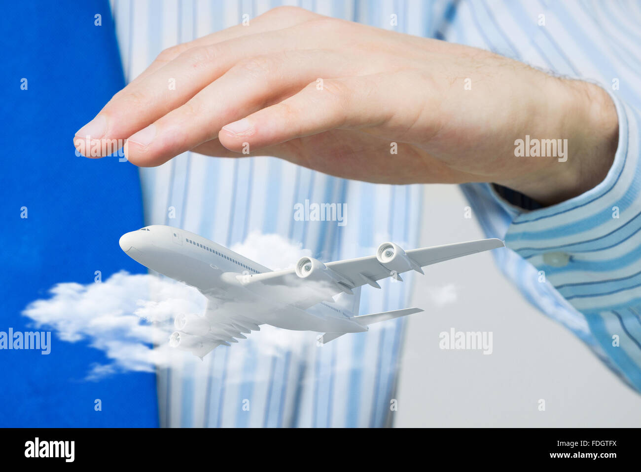 Hands of businessman and model of flying airplane Stock Photo - Alamy