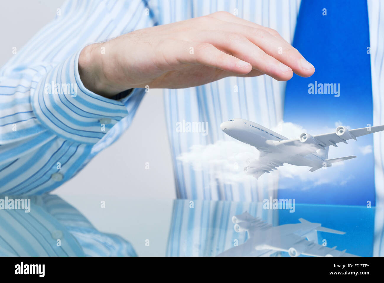 Hands of businessman and model of flying airplane Stock Photo - Alamy