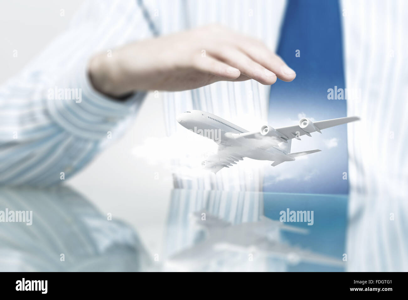 Hands of businessman and model of flying airplane Stock Photo - Alamy