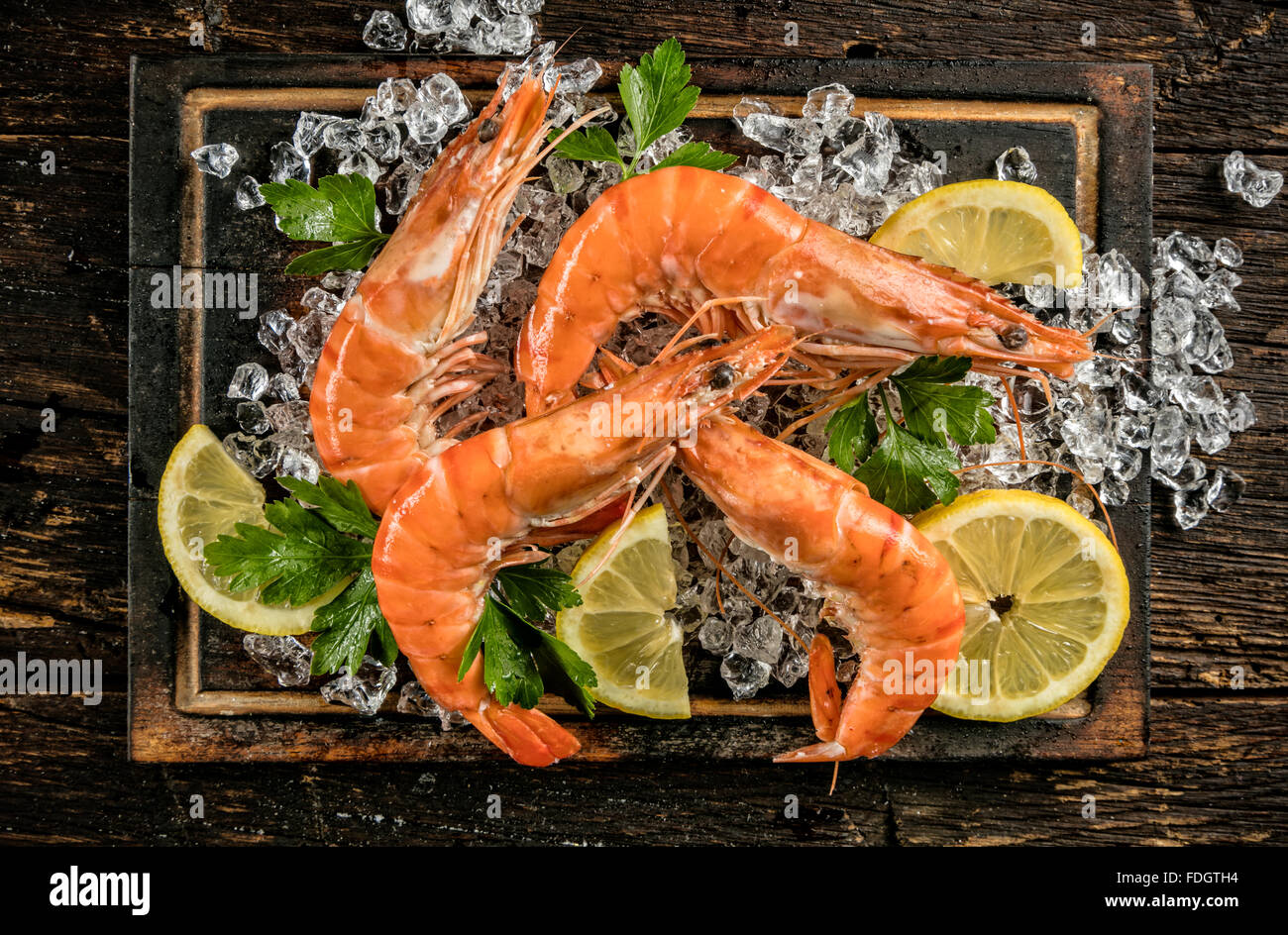 Cooked prawns served on dark wood Stock Photo - Alamy