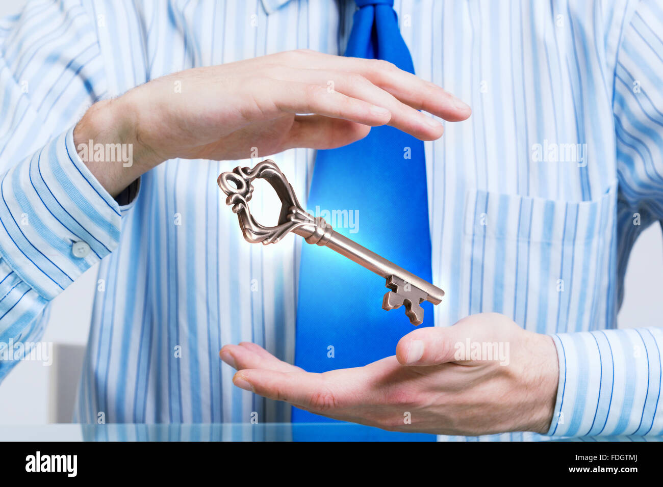 Hands of businessman holding with care old key Stock Photo - Alamy