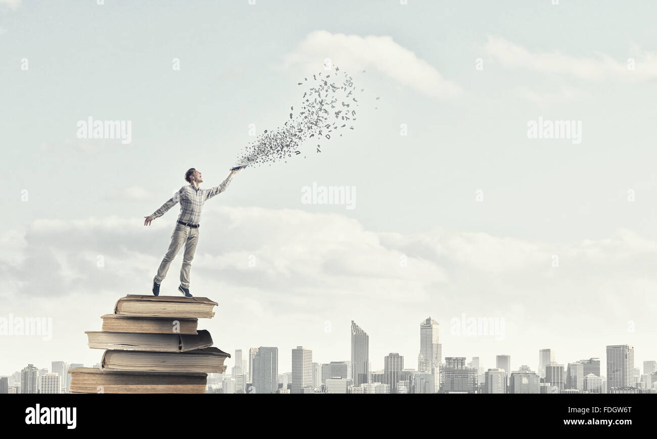 Young handsome man reaching hand with book and characters flying out ...