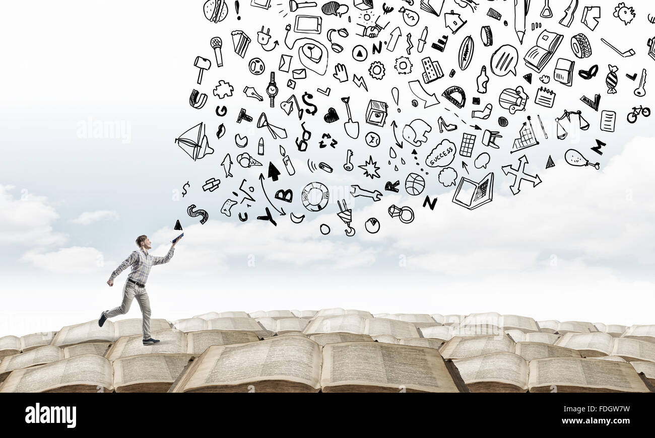 Young handsome man reaching hand with book and characters flying out ...