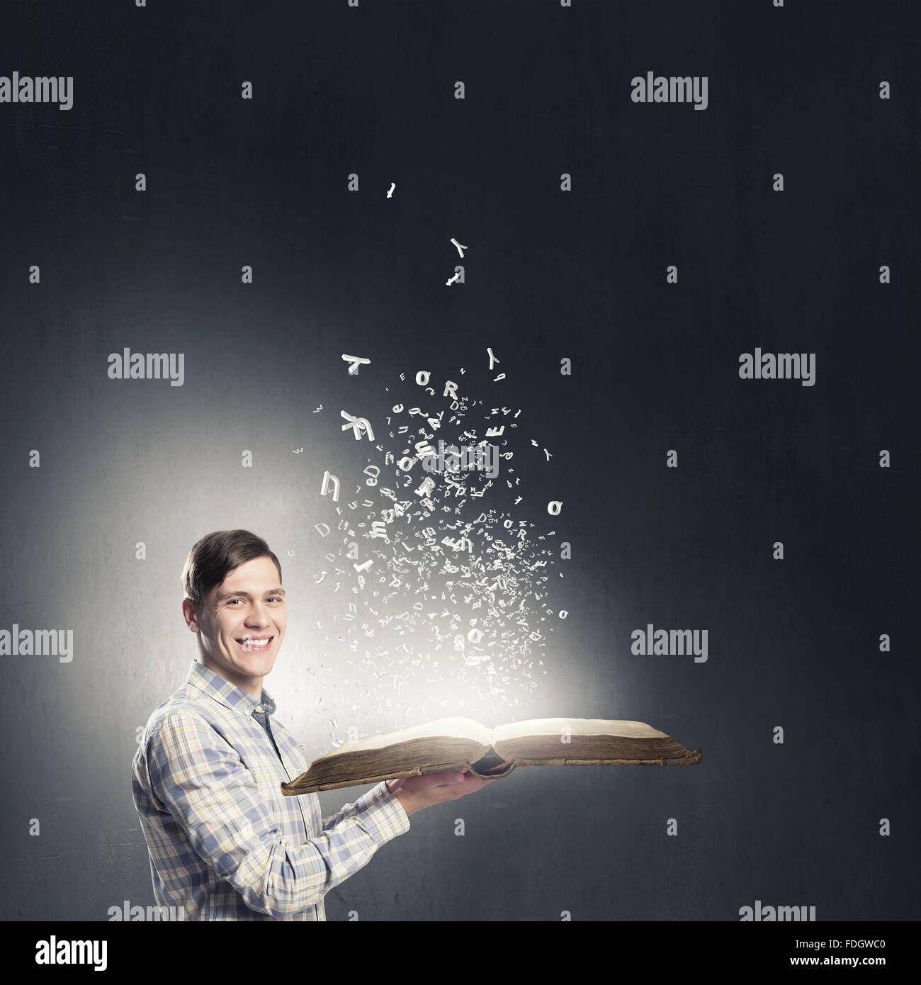 Young student guy with opened book in hands Stock Photo - Alamy