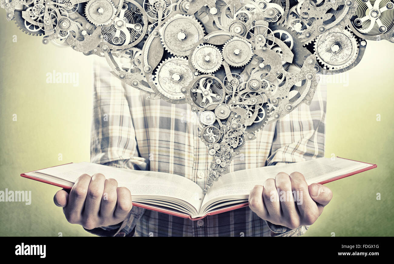 Young guy with opened book and gears flying out Stock Photo - Alamy