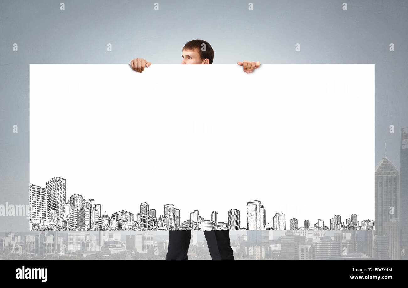 Businessman holding banner with urban construction concept Stock Photo ...