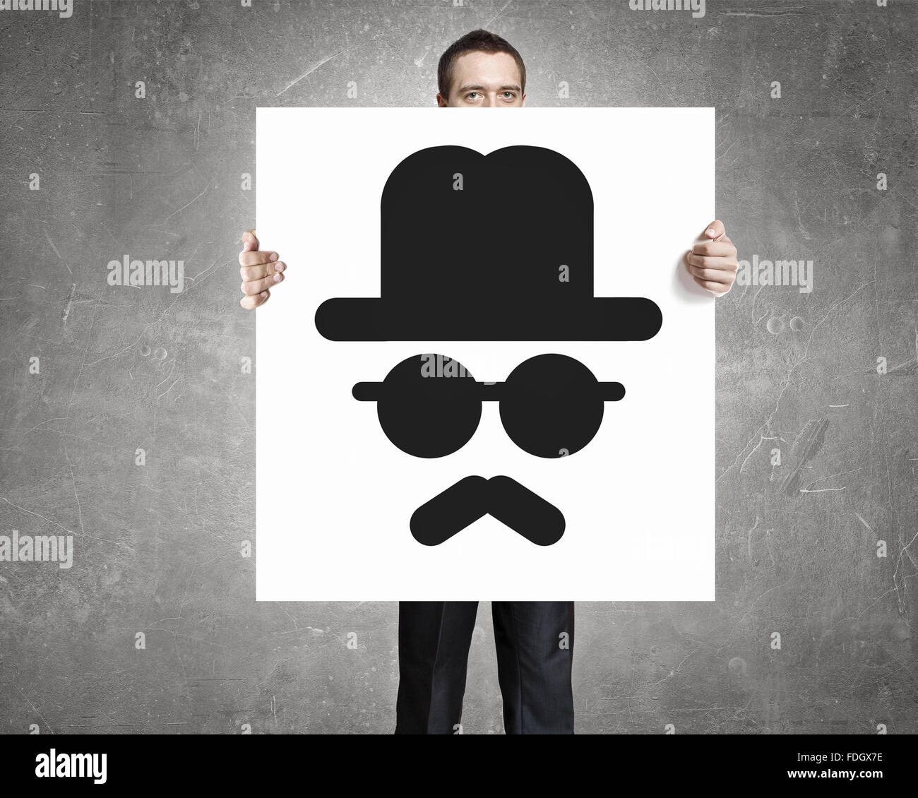 Businessman holding and hiding behind card with smiley face emoticon ...