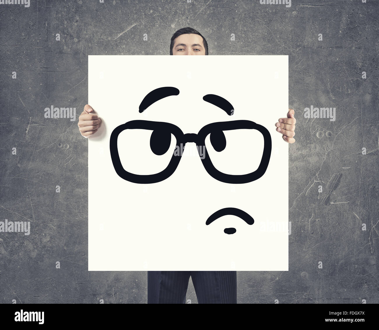 Businessman hold white board with sad face emoticon Stock Photo - Alamy