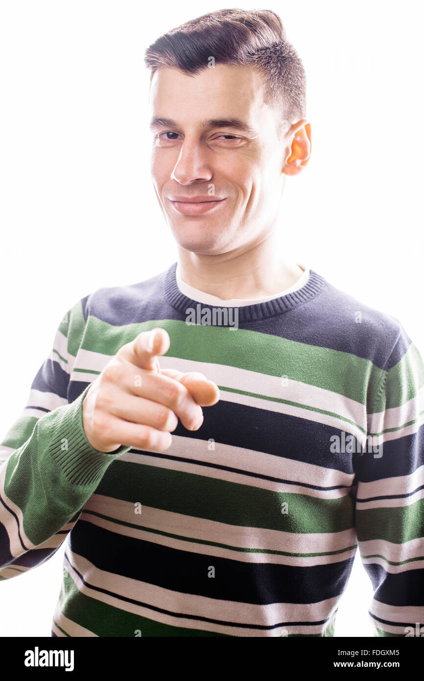 Portrait of a smart serious young man standing against white background ...