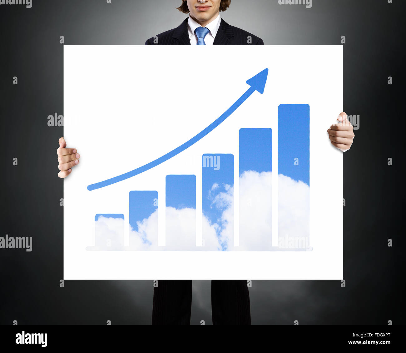 Businessman holding poster with growing arrow graph Stock Photo - Alamy
