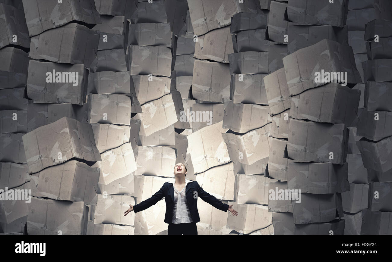 Businesswoman screaming among pile of carton boxes Stock Photo - Alamy