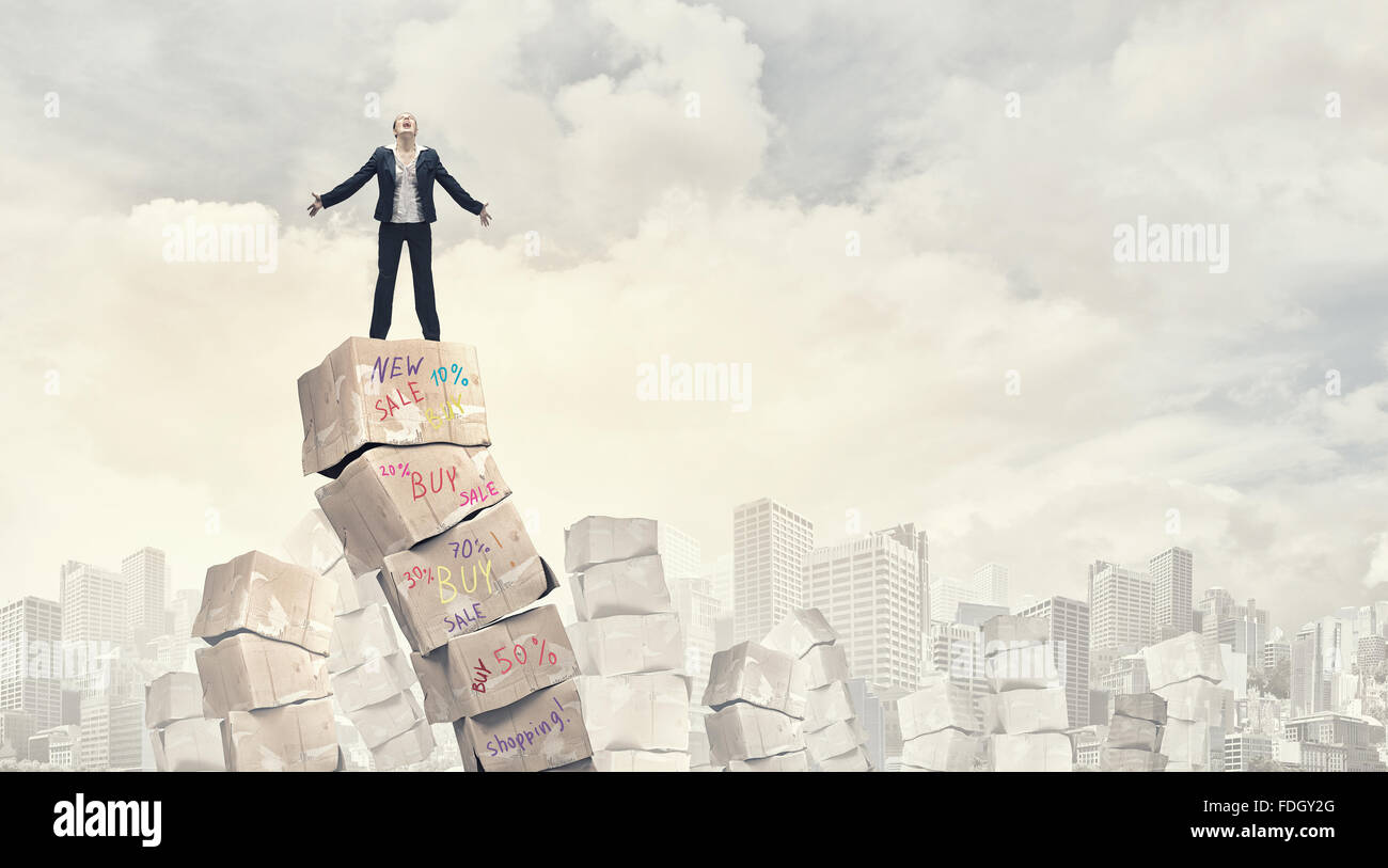 Businesswoman screaming among pile of carton boxes Stock Photo - Alamy