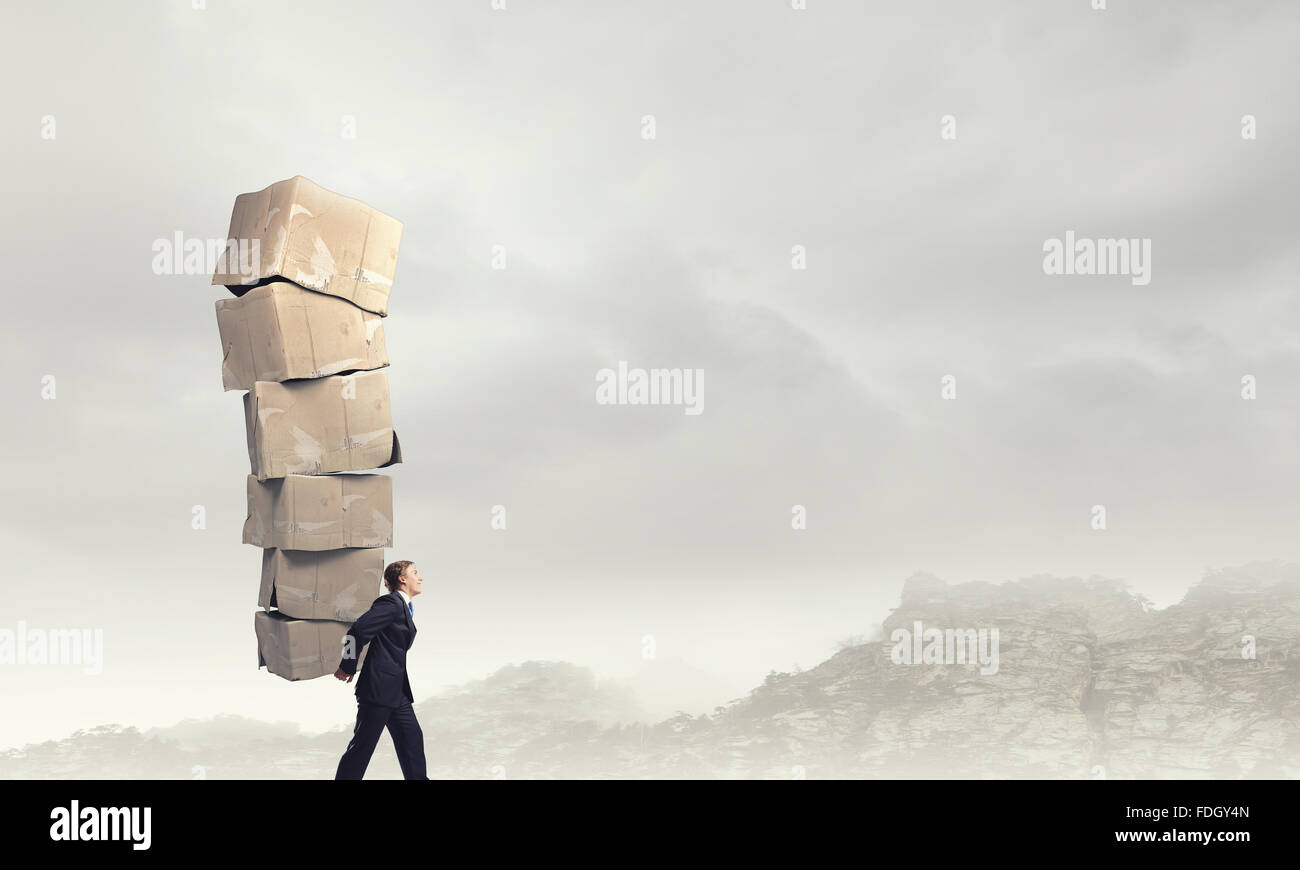 Businessman carrying big stack of carton boxes Stock Photo - Alamy