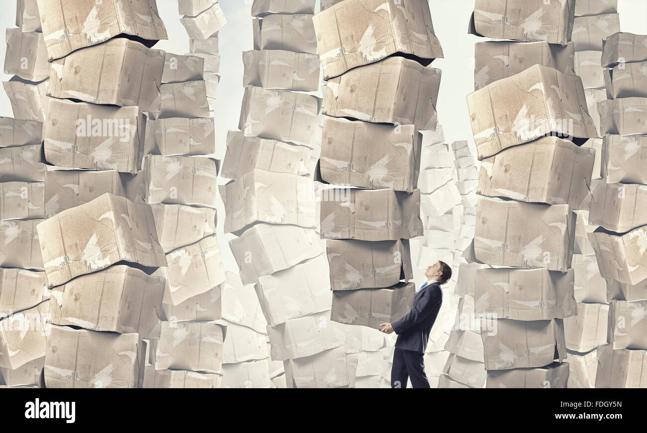 Businessman carrying big stack of carton boxes Stock Photo - Alamy