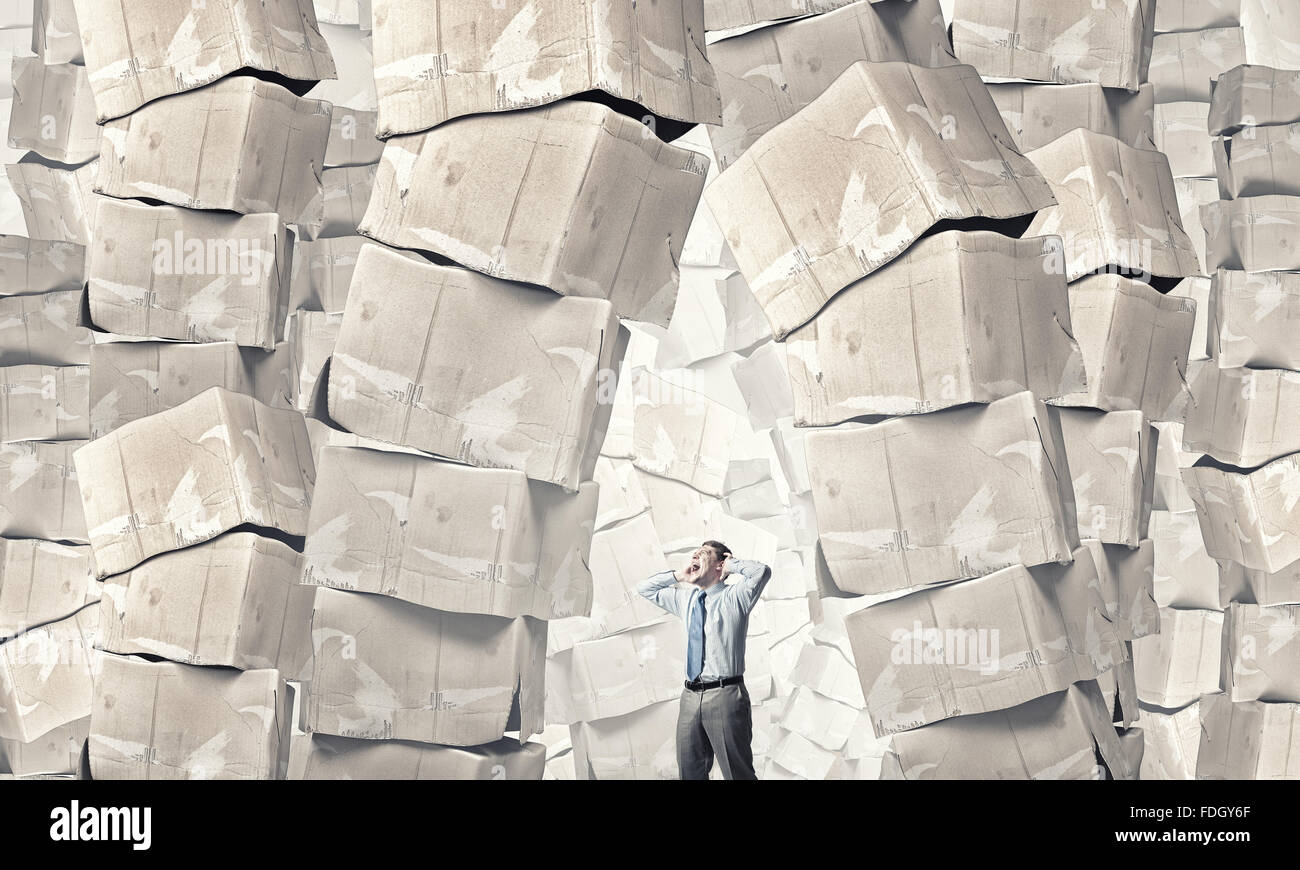 Young businessman and stack of carton boxes behind him Stock Photo - Alamy