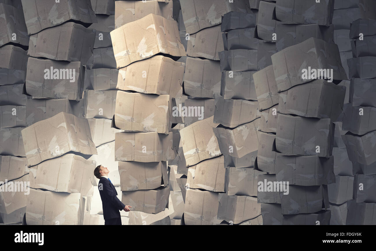 Businessman carrying big stack of carton boxes Stock Photo - Alamy