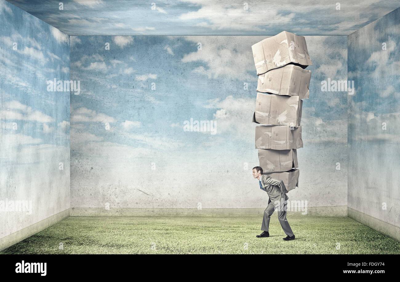 Young businessman in suit carrying big stack of carton boxes Stock ...