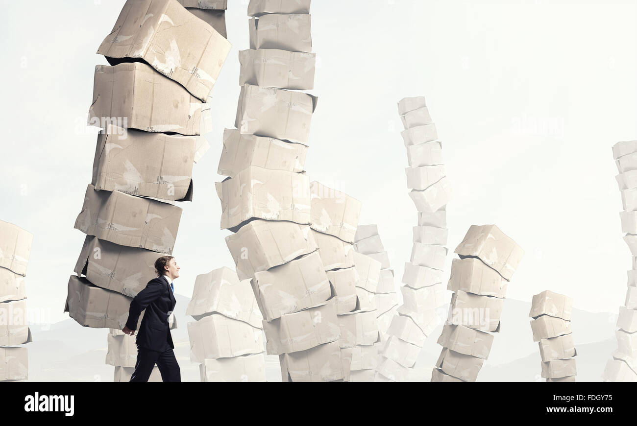 Businessman carrying big stack of carton boxes Stock Photo - Alamy