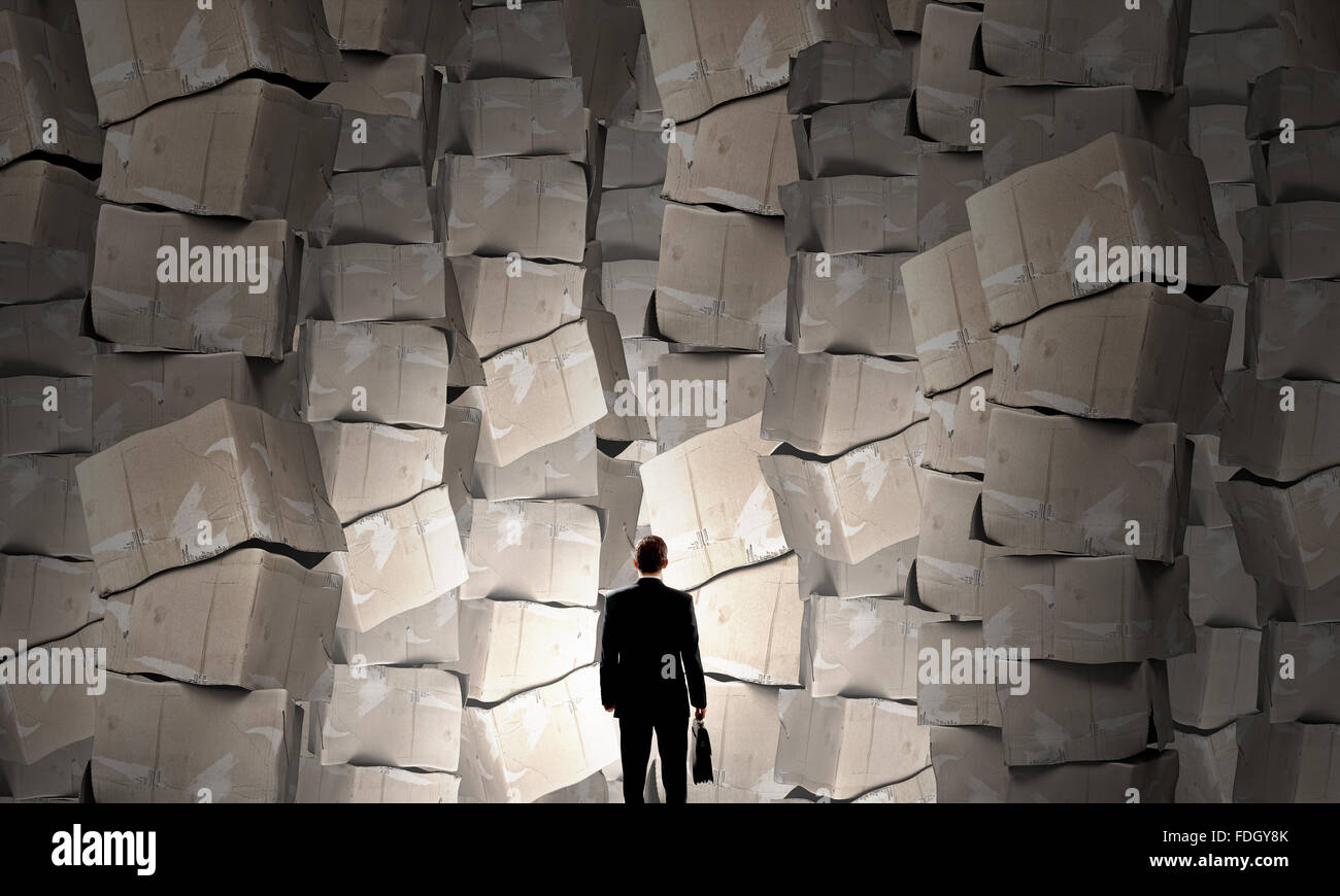 Young businessman and stack of carton boxes behind him Stock Photo - Alamy