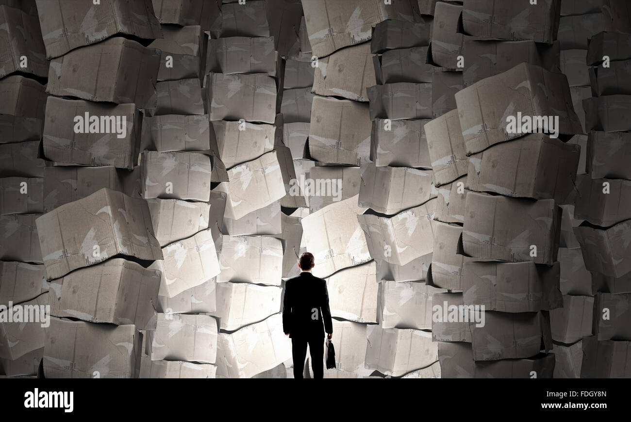 Young businessman and stack of carton boxes behind him Stock Photo - Alamy