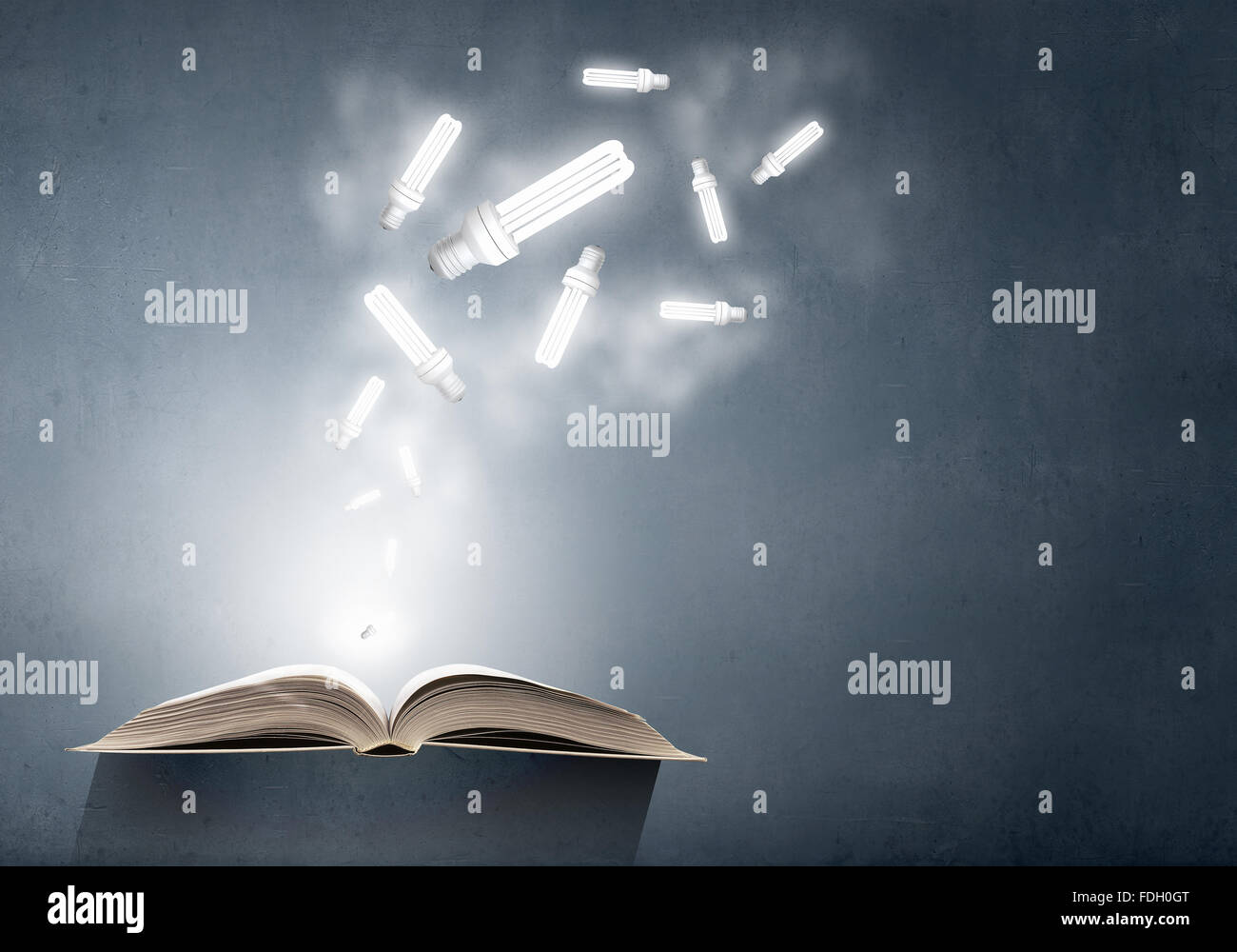 Opened book and glowing light bulbs flying from pages Stock Photo - Alamy