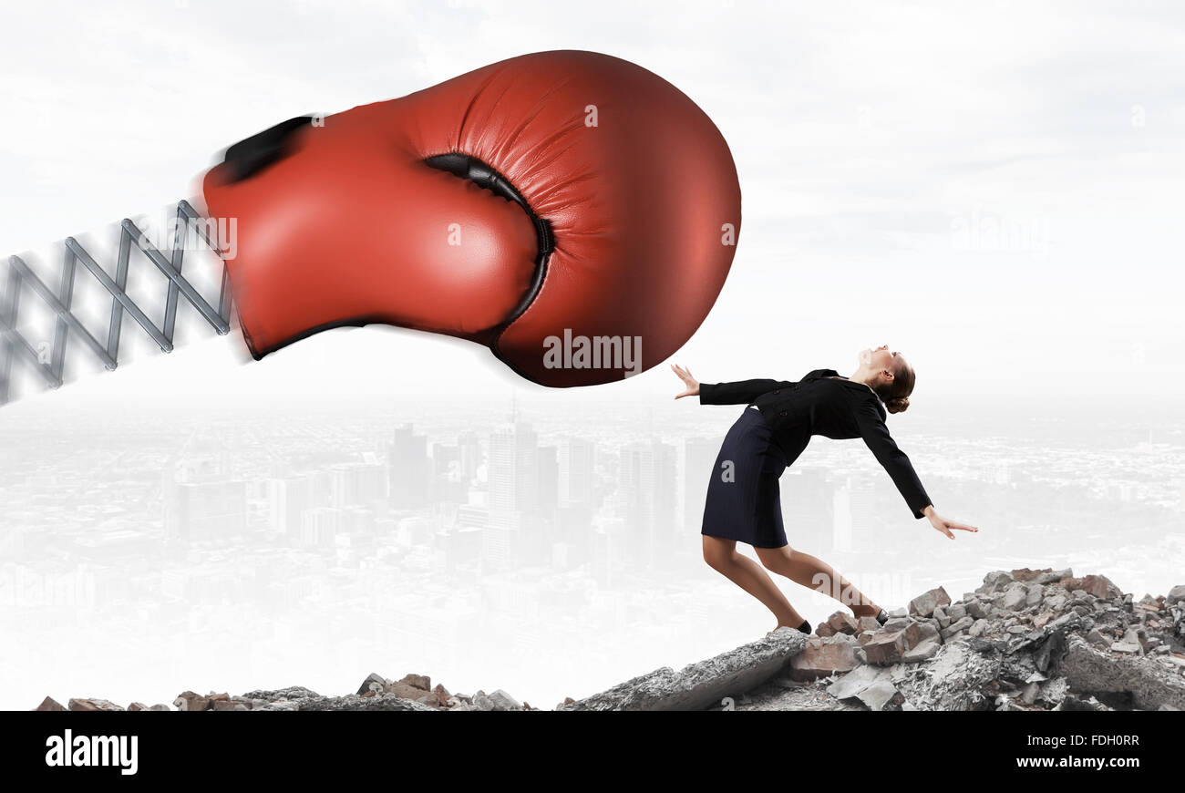 Boxing glove on spring striking businesswoman down Stock Photo - Alamy