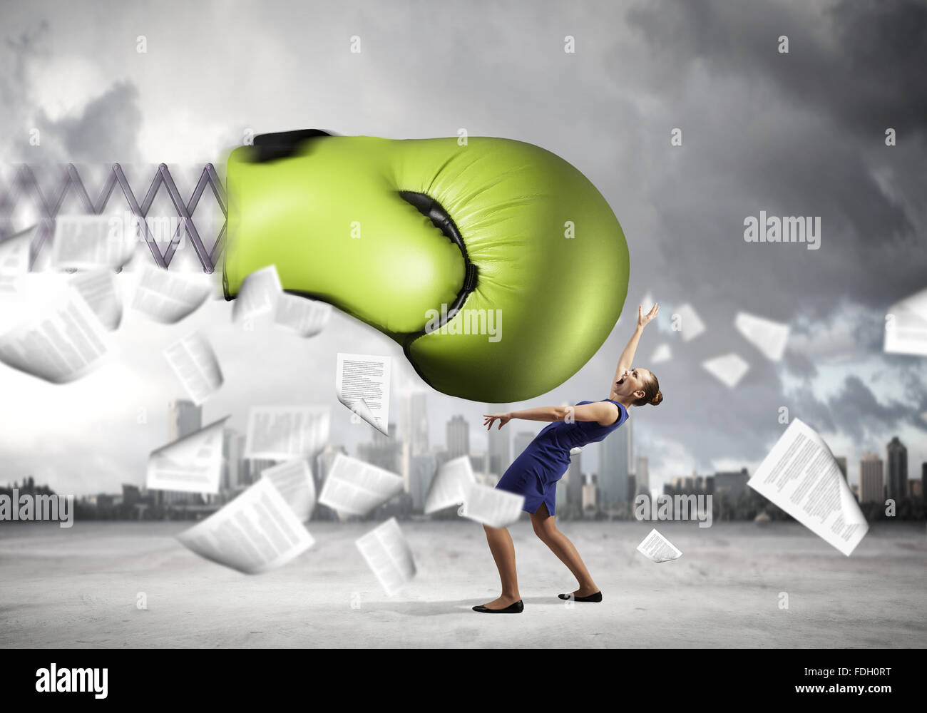Boxing glove on spring striking businesswoman down Stock Photo - Alamy